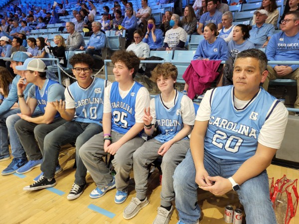 Group uniquely supports UNC women, wearing jerseys of players on the court